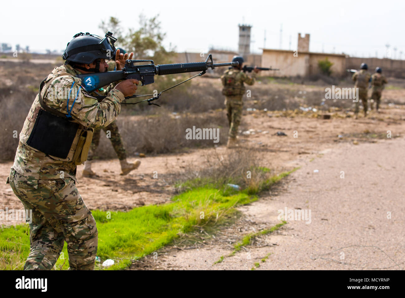 An Iraqi soldier uses a hand signal during a squad movement while ...