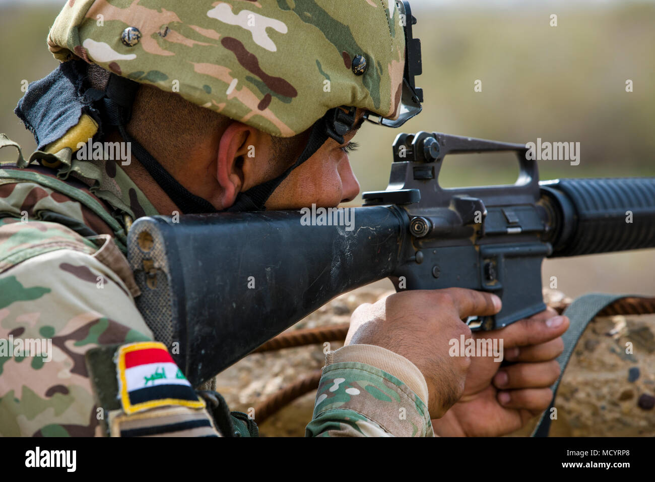 An Iraqi soldier, with the Commando Battalion, 11th Division, provides ...