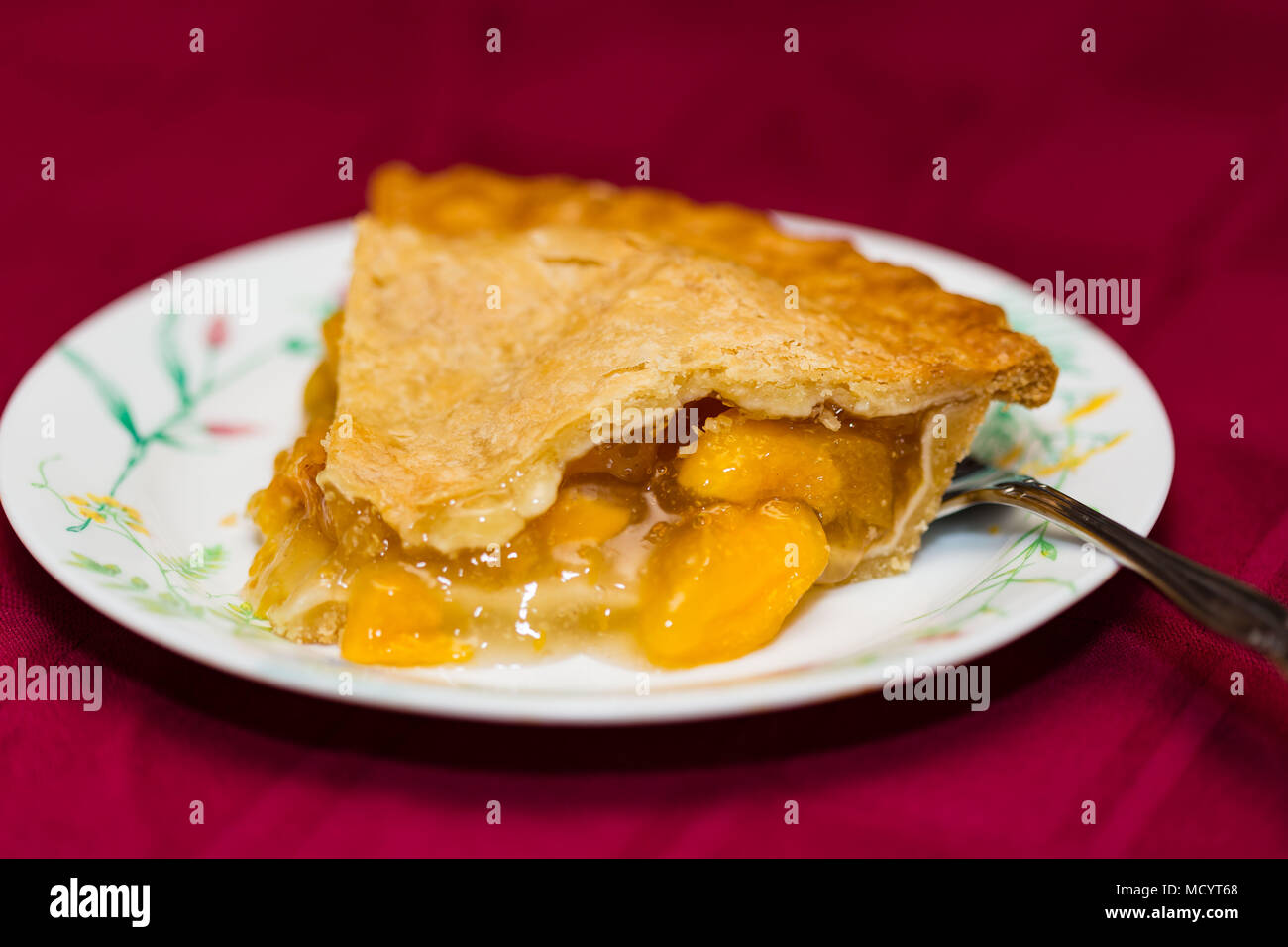 one slice of peach pie one a plate ready to go Stock Photo - Alamy