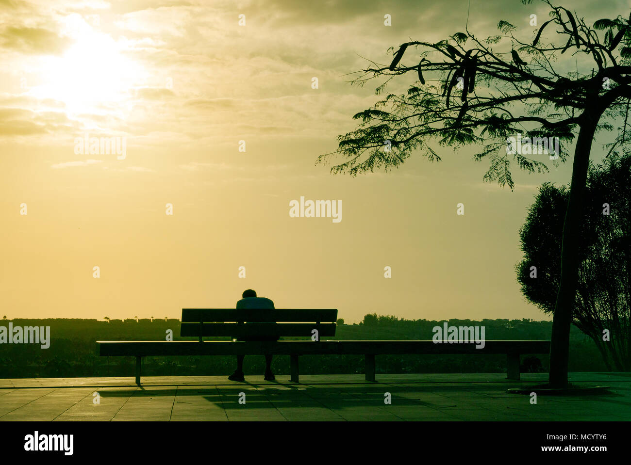 Depressed man sitting on park bench hi-res stock photography and images ...