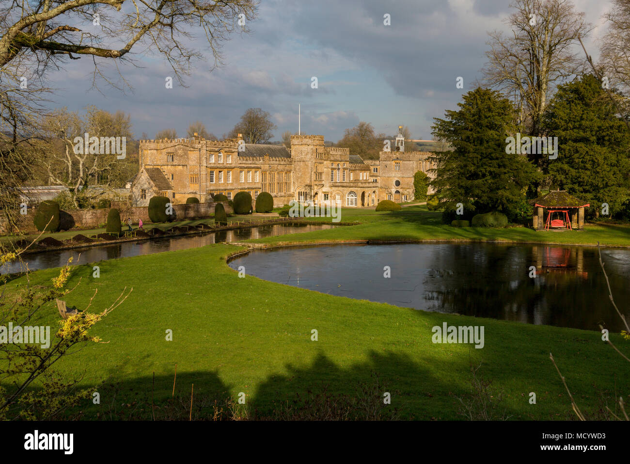 Winter sunshine lights up the facade of Forde Abbey with the frozen ...