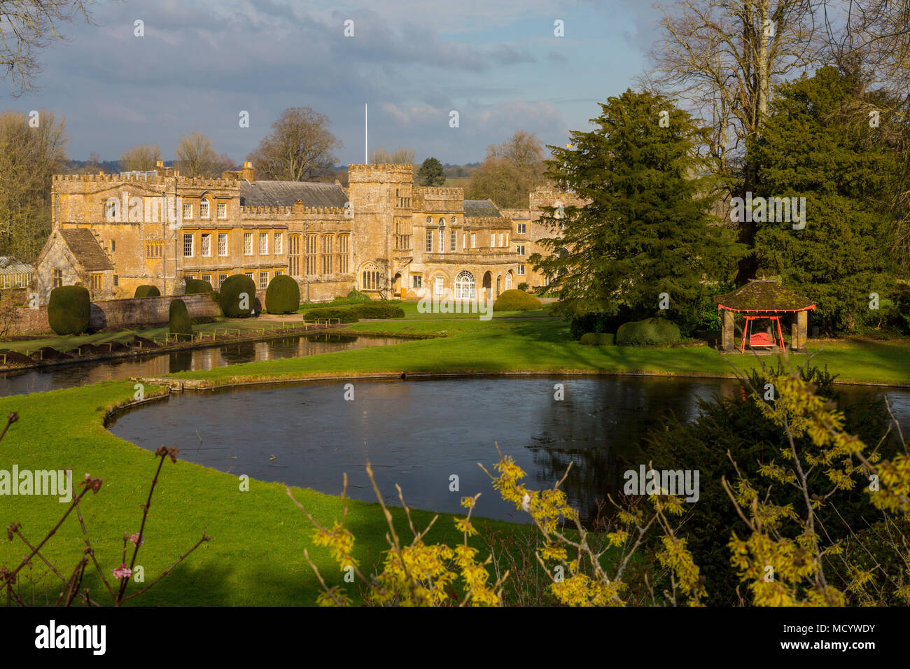 Winter sunshine lights up the facade of Forde Abbey with the frozen ...