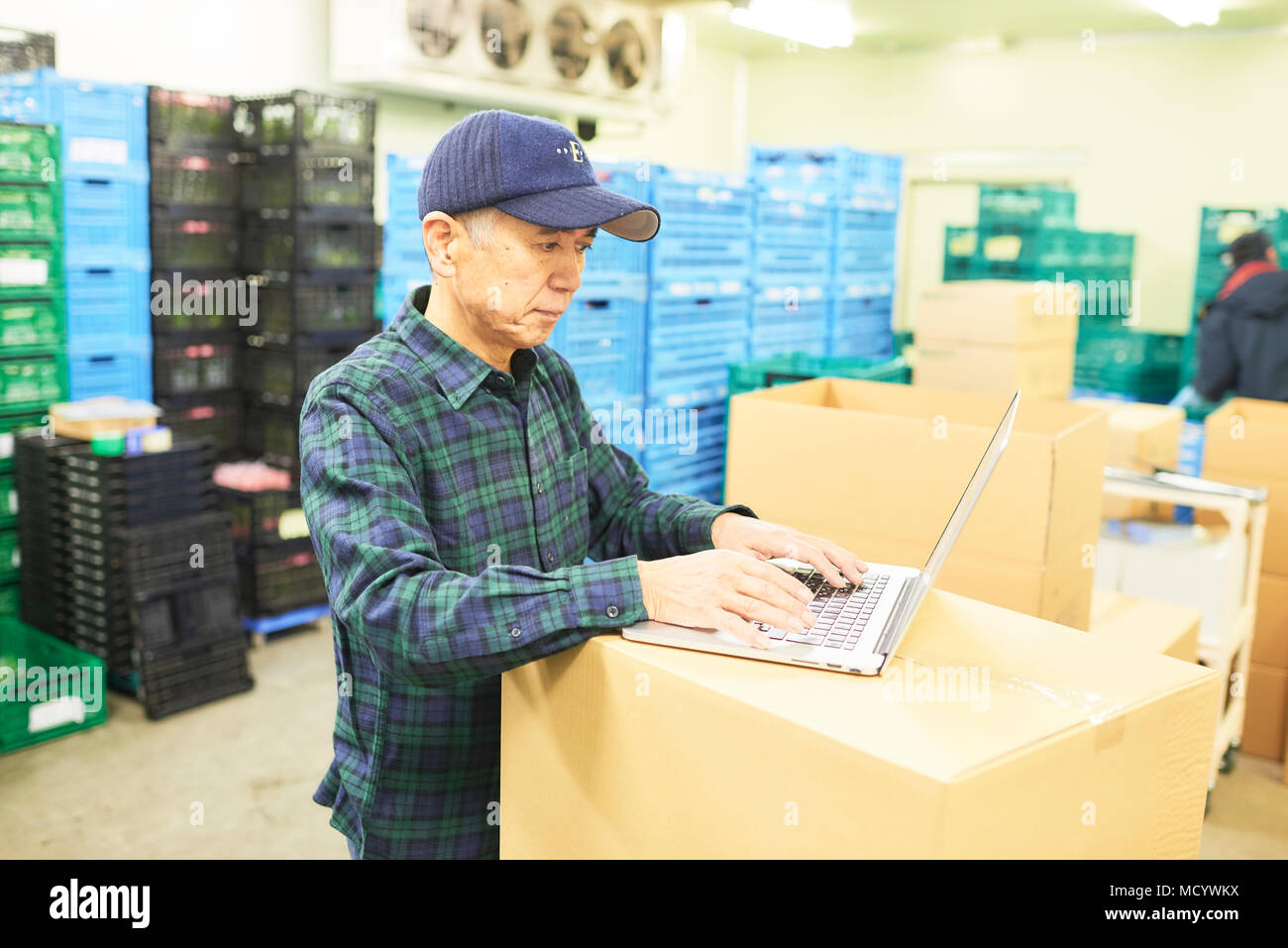 Senior man arranging products in warehouse Stock Photo - Alamy