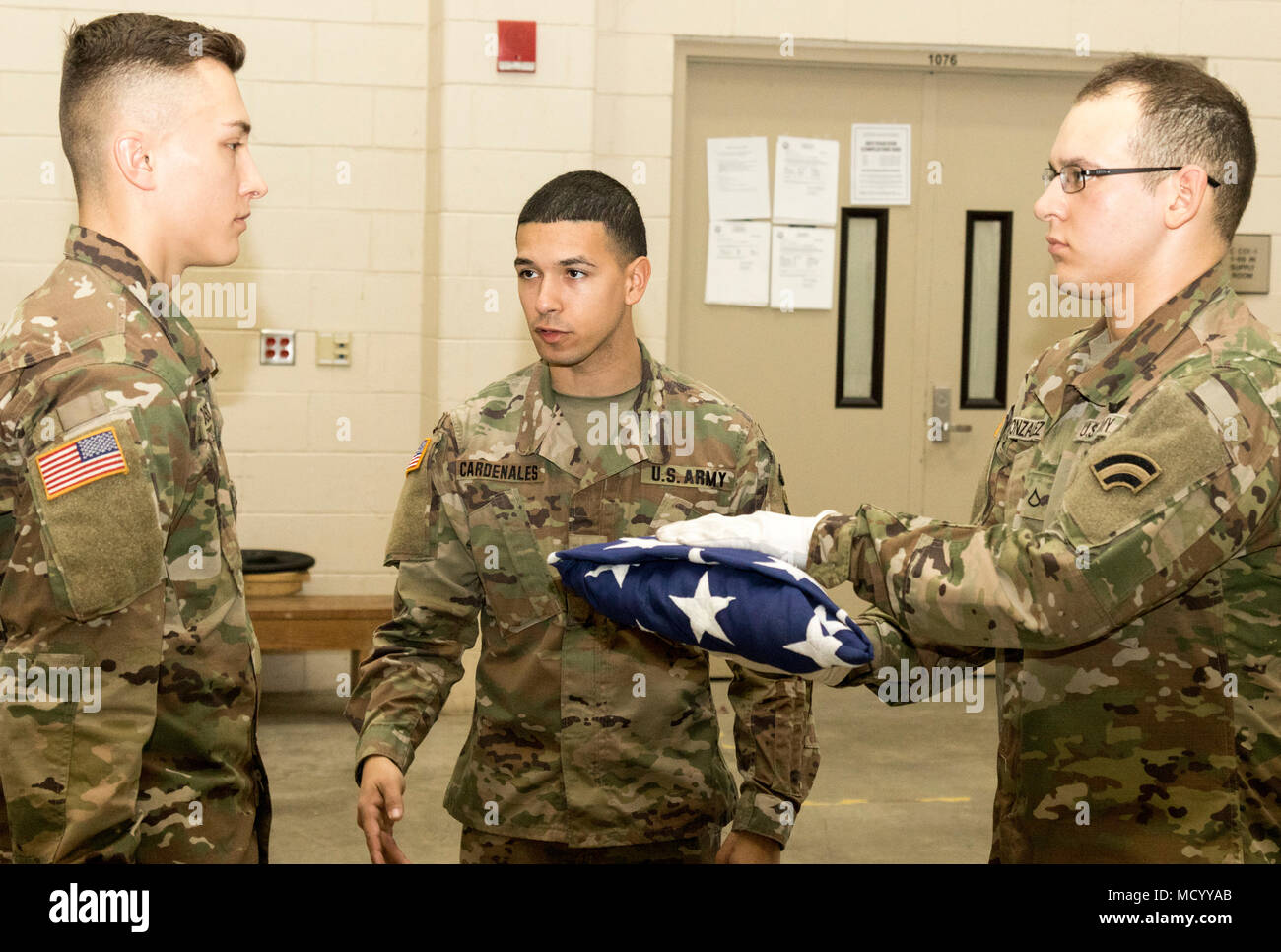 New York Army National Guard Soldiers practice passing and folding the ...