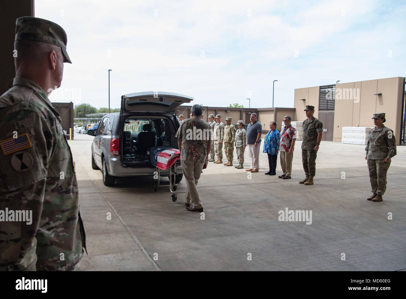 Members of the Defense POW/MIA Accounting Agency (DPAA) line the path ...