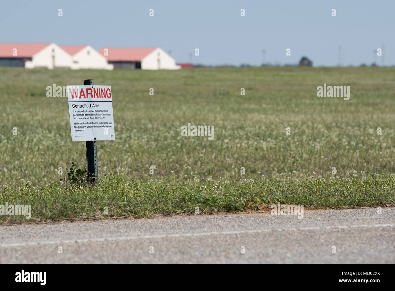 A warning sign informs the public that beyond this point is a ...