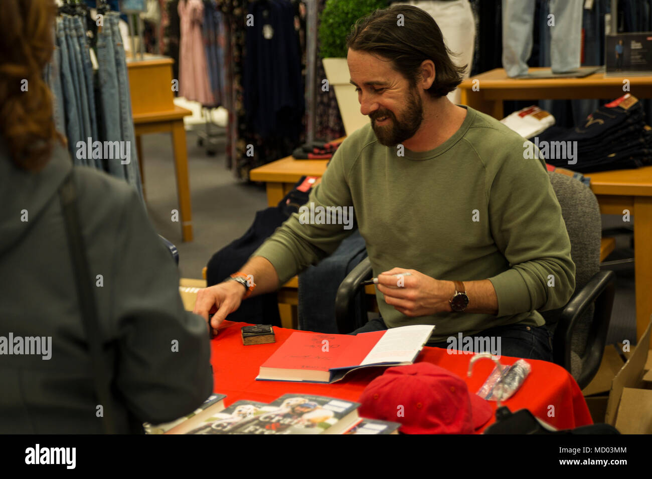Craig Grossi, a Marine veteran and author, signs a copy of his book for ...