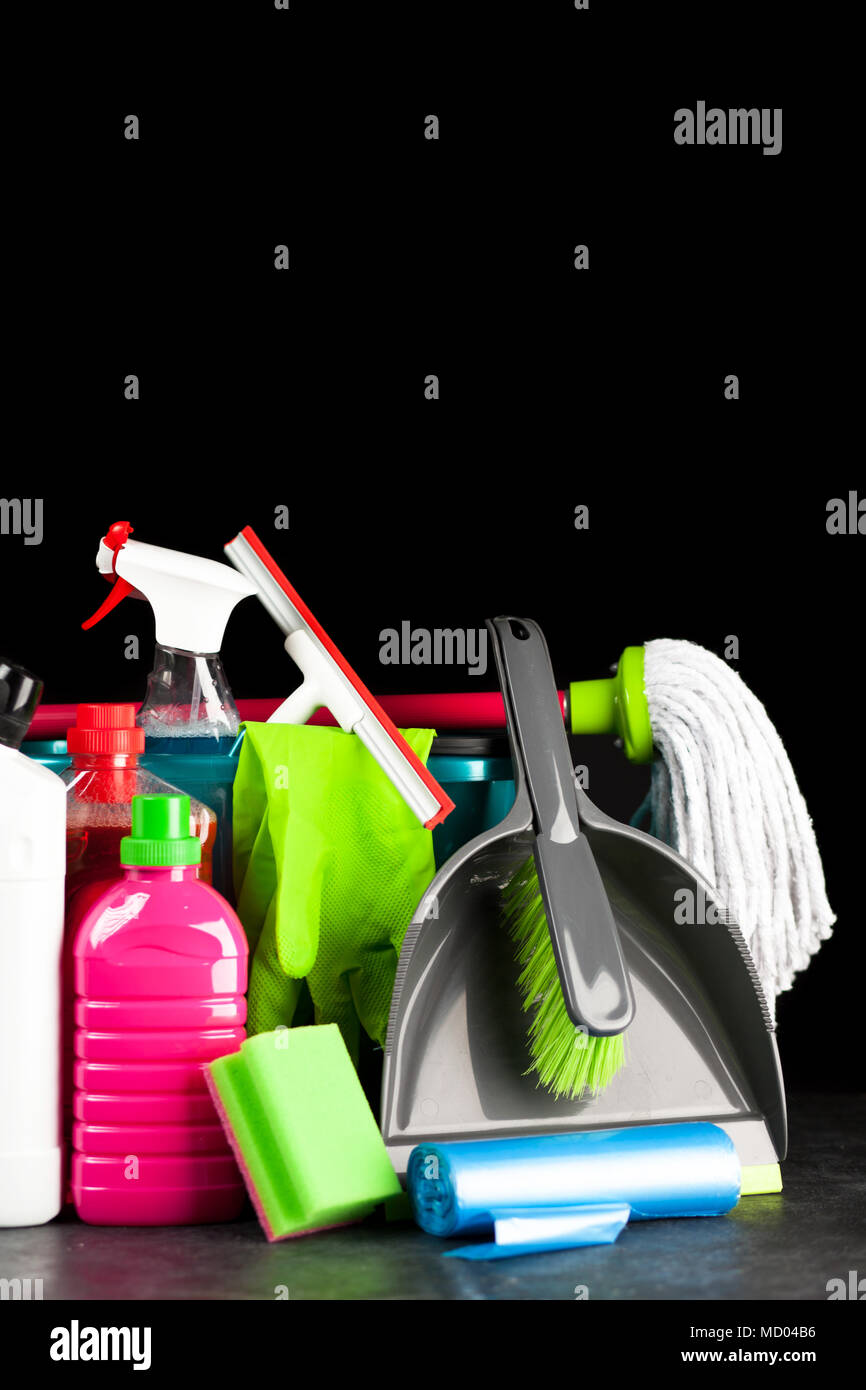 Cleaning supplies on black background Stock Photo - Alamy