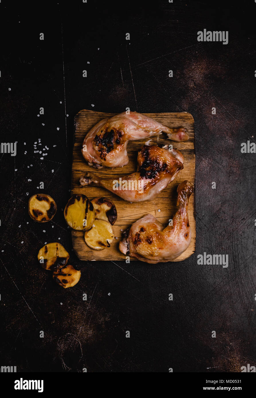top view of delicious grilled chicken legs on wooden board Stock Photo ...