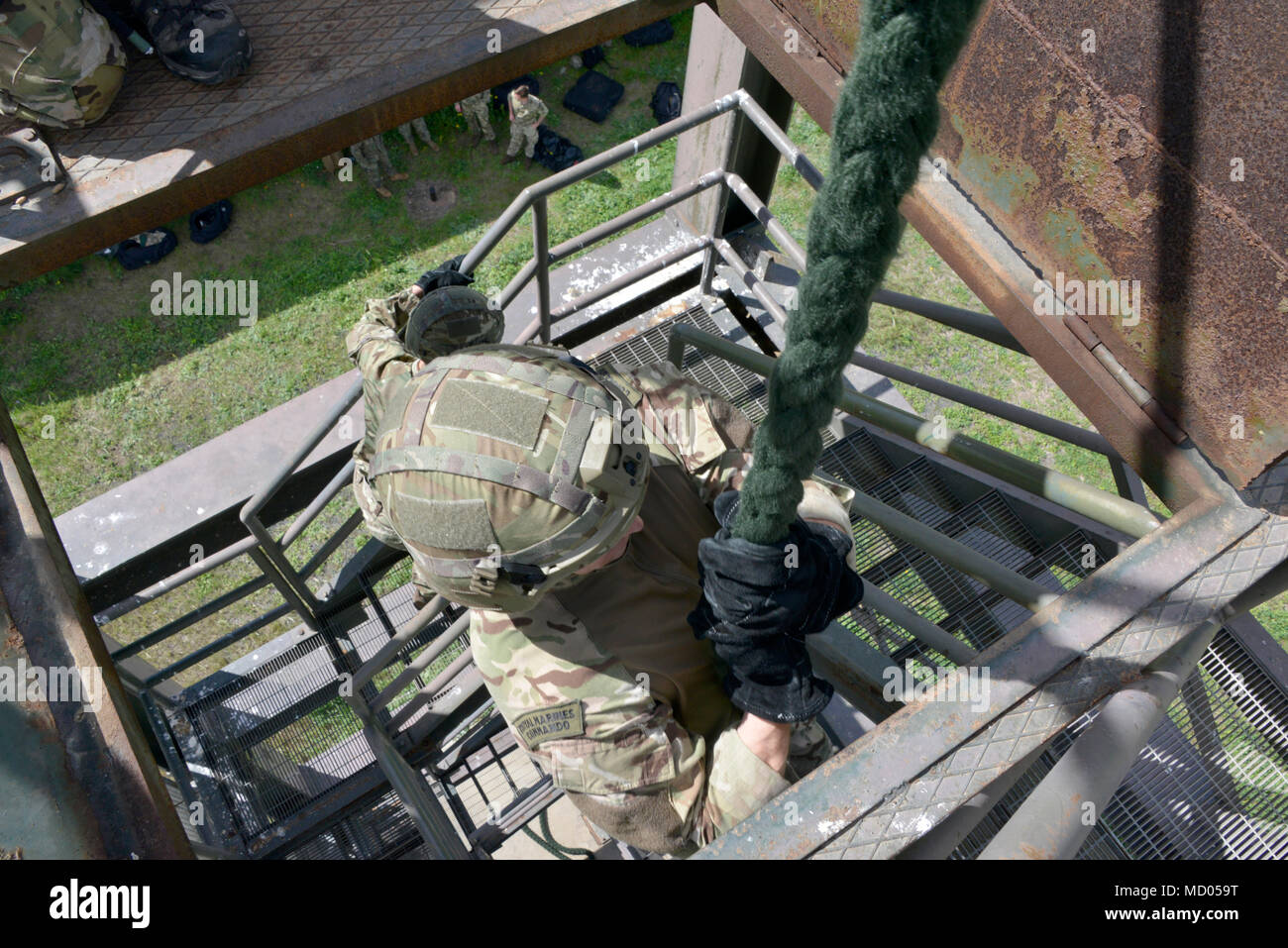 A British Royal Marine commando fast ropes during a training exercise ...