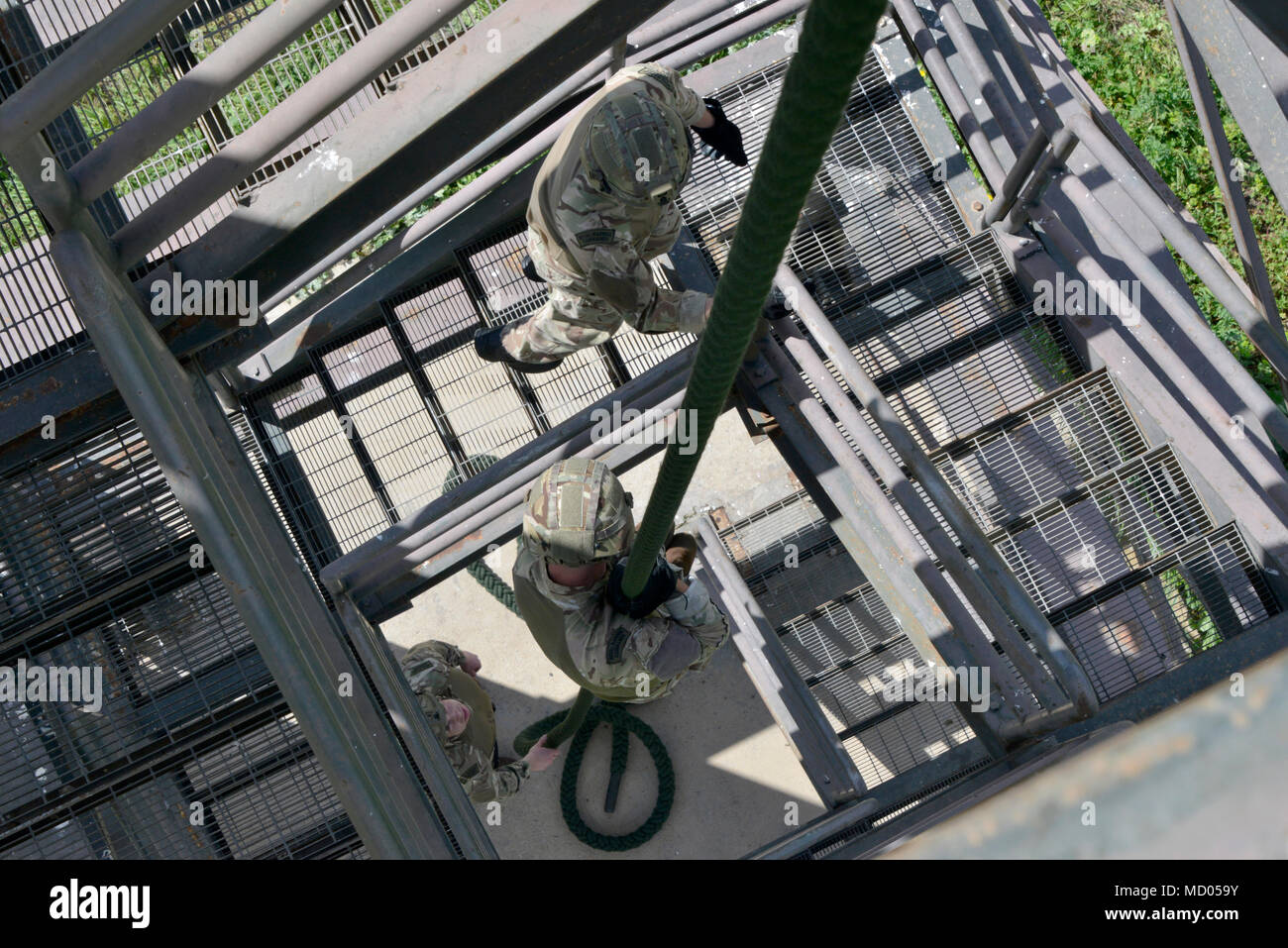 A British Royal Marine commando fast ropes during a training exercise ...