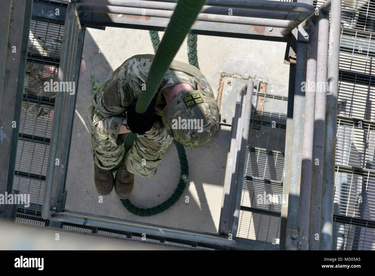 A British Royal Marine commando fast ropes during a training exercise ...