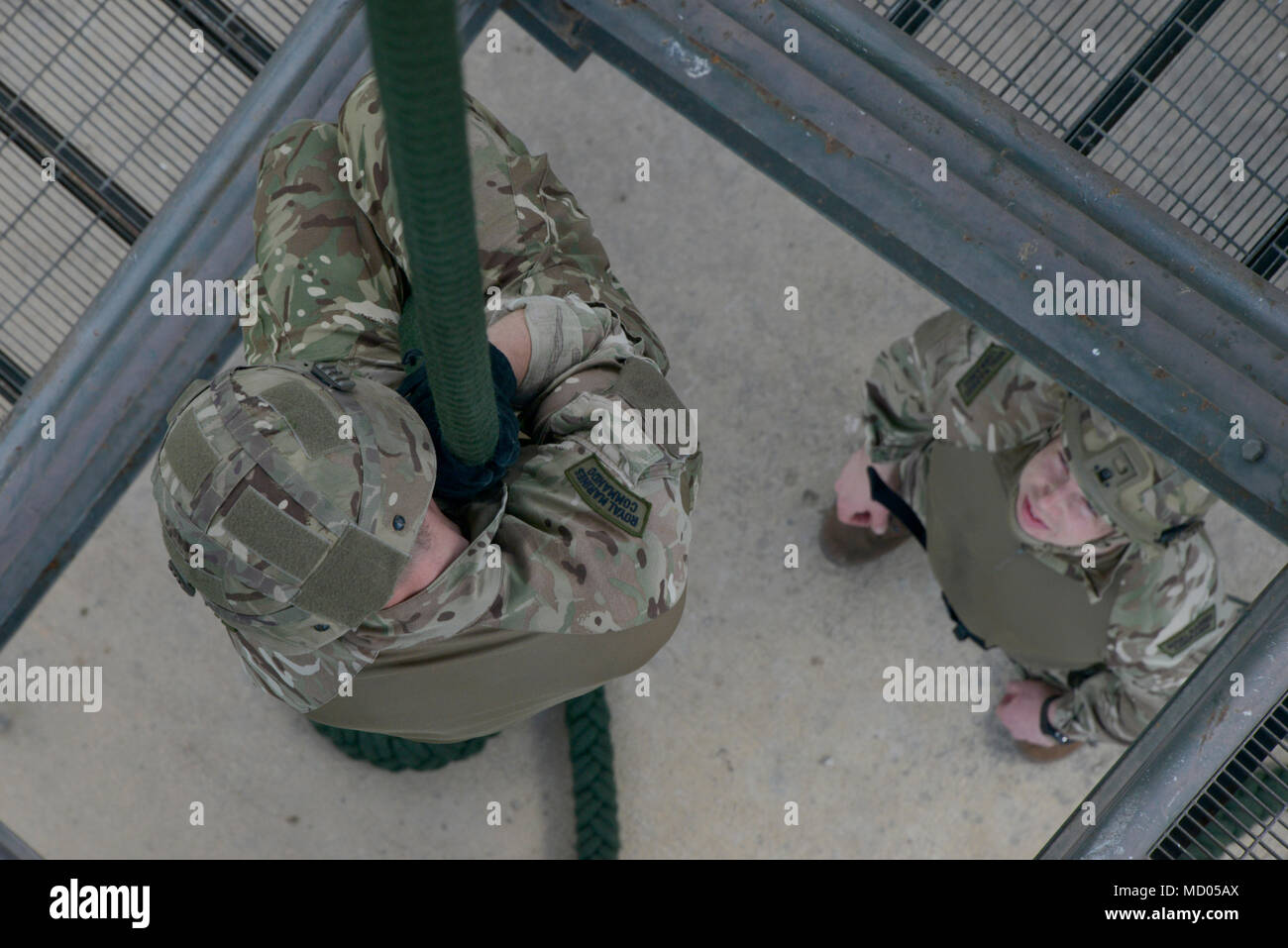 A British Royal Marine commando fast ropes during a training exercise ...