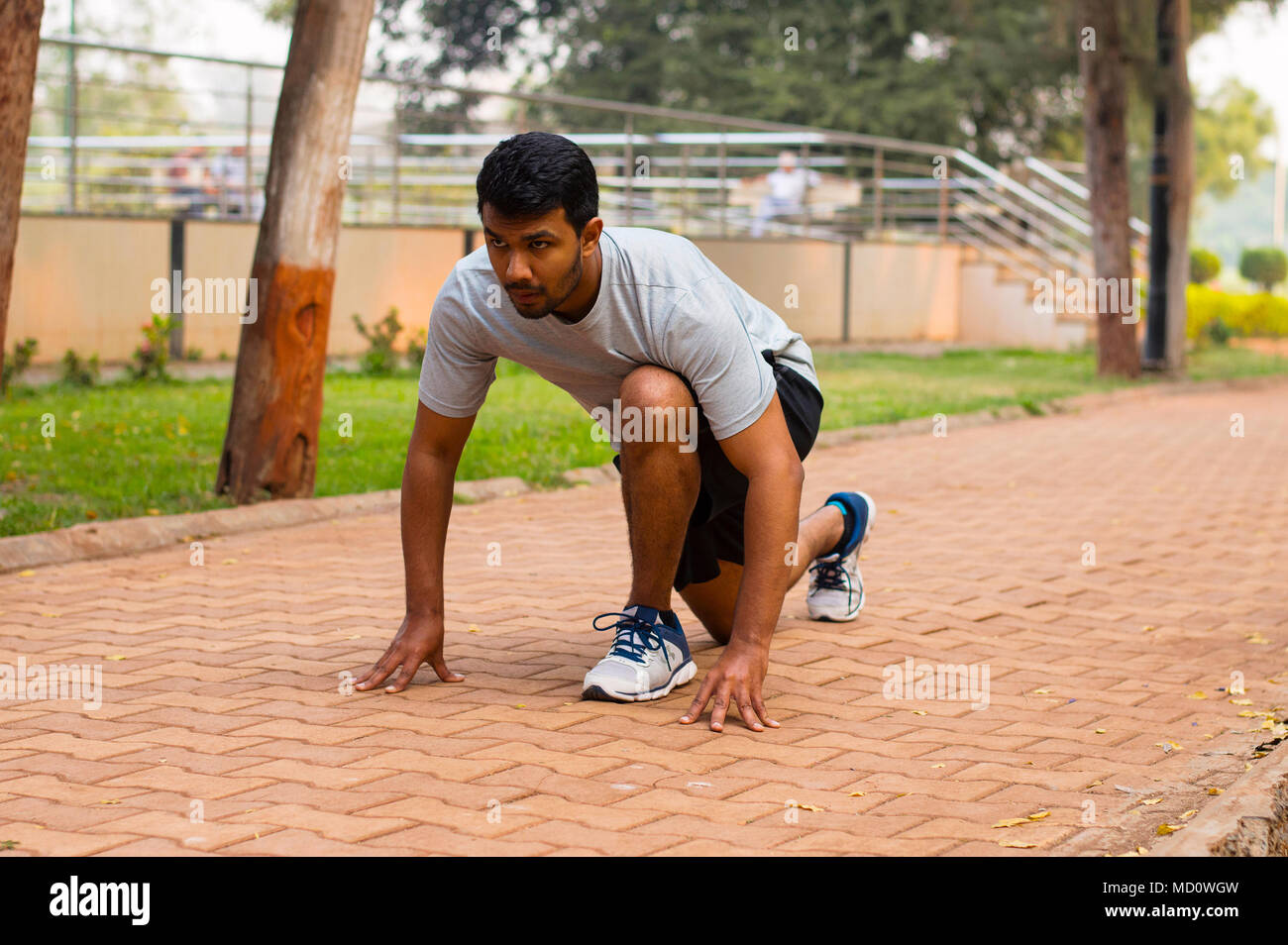 Young athlete in the ready position before going for a run Stock Photo ...
