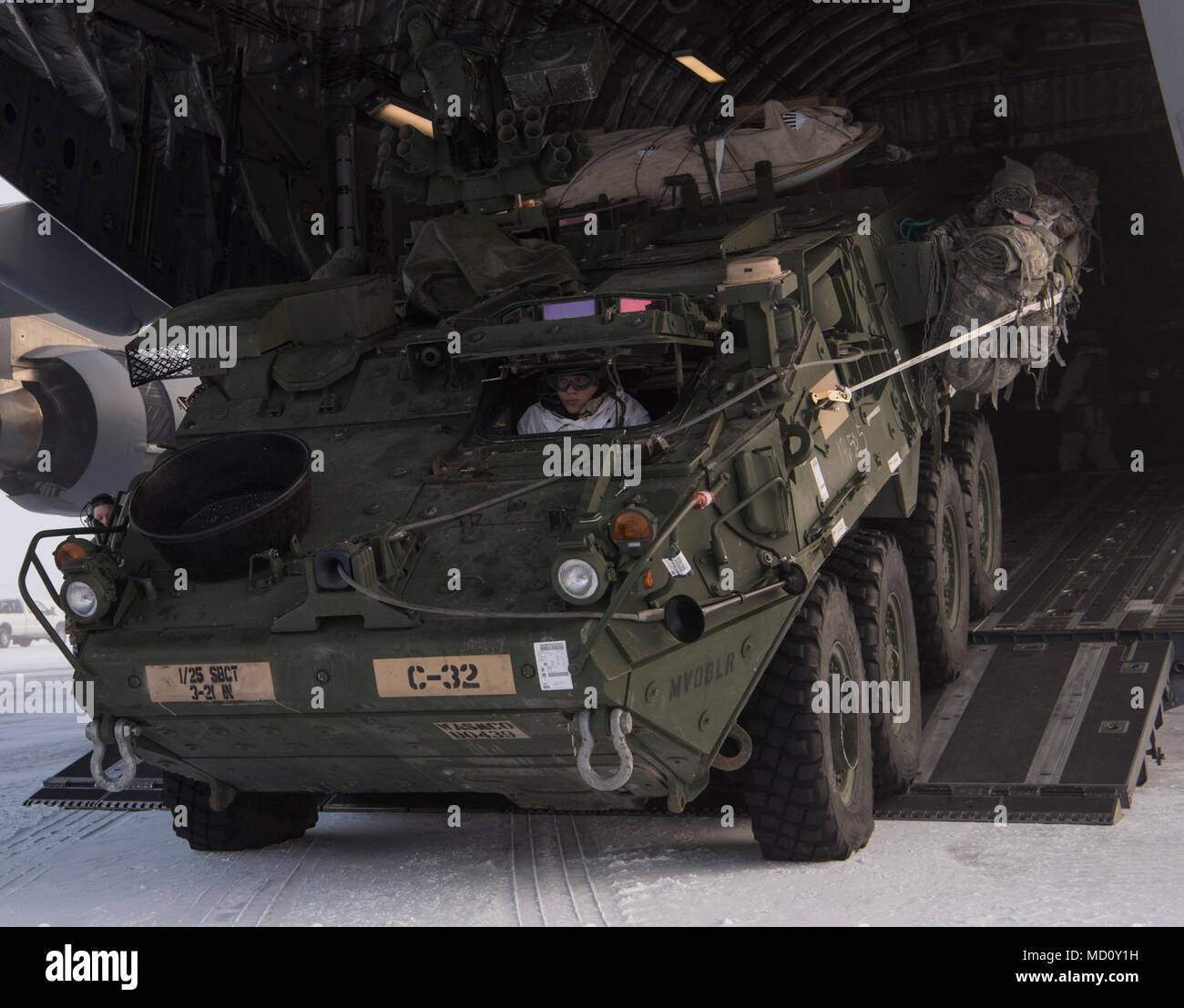 A U.S. Army Soldier drives an Interim Armored Vehicle Stryker out of a ...