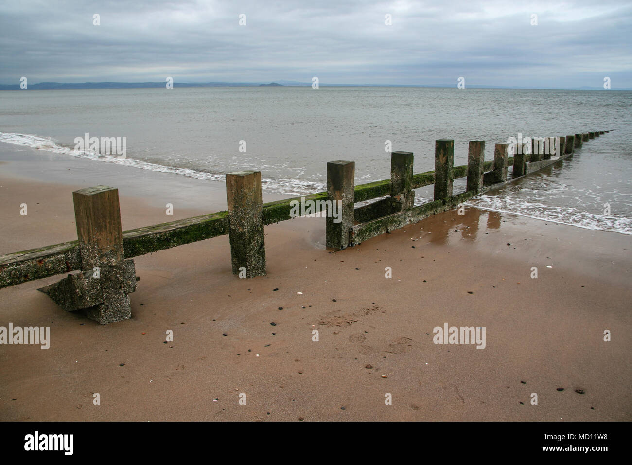 Old timber sea groynes hi-res stock photography and images - Alamy