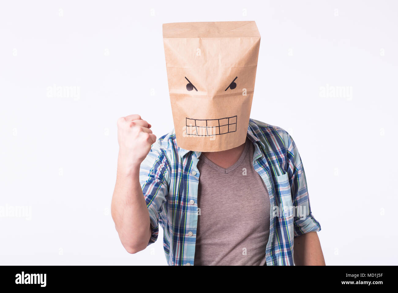 Man with cardboard box on his head and drawing of angry emoticon face ...