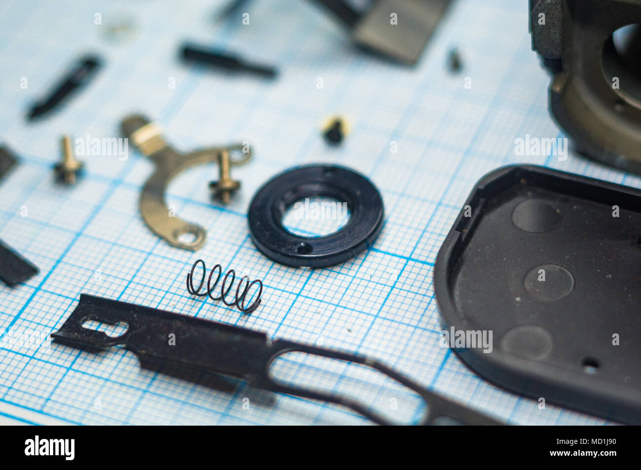 parts are completely disassembled old retro film SLR camera on graph ...