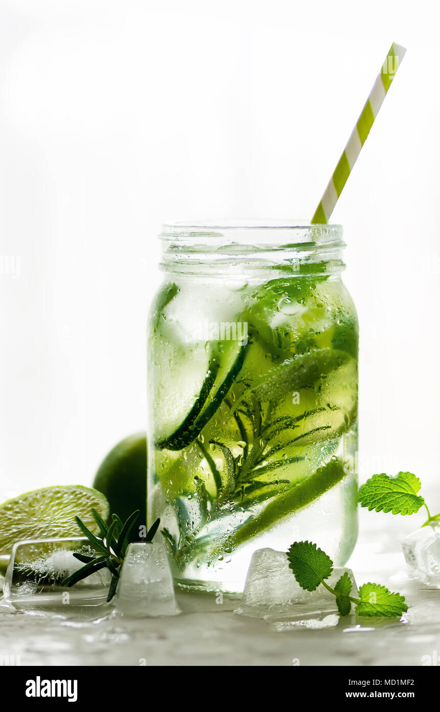 Homemade lime lemonade with cucumber, rosemary and ice, white ...