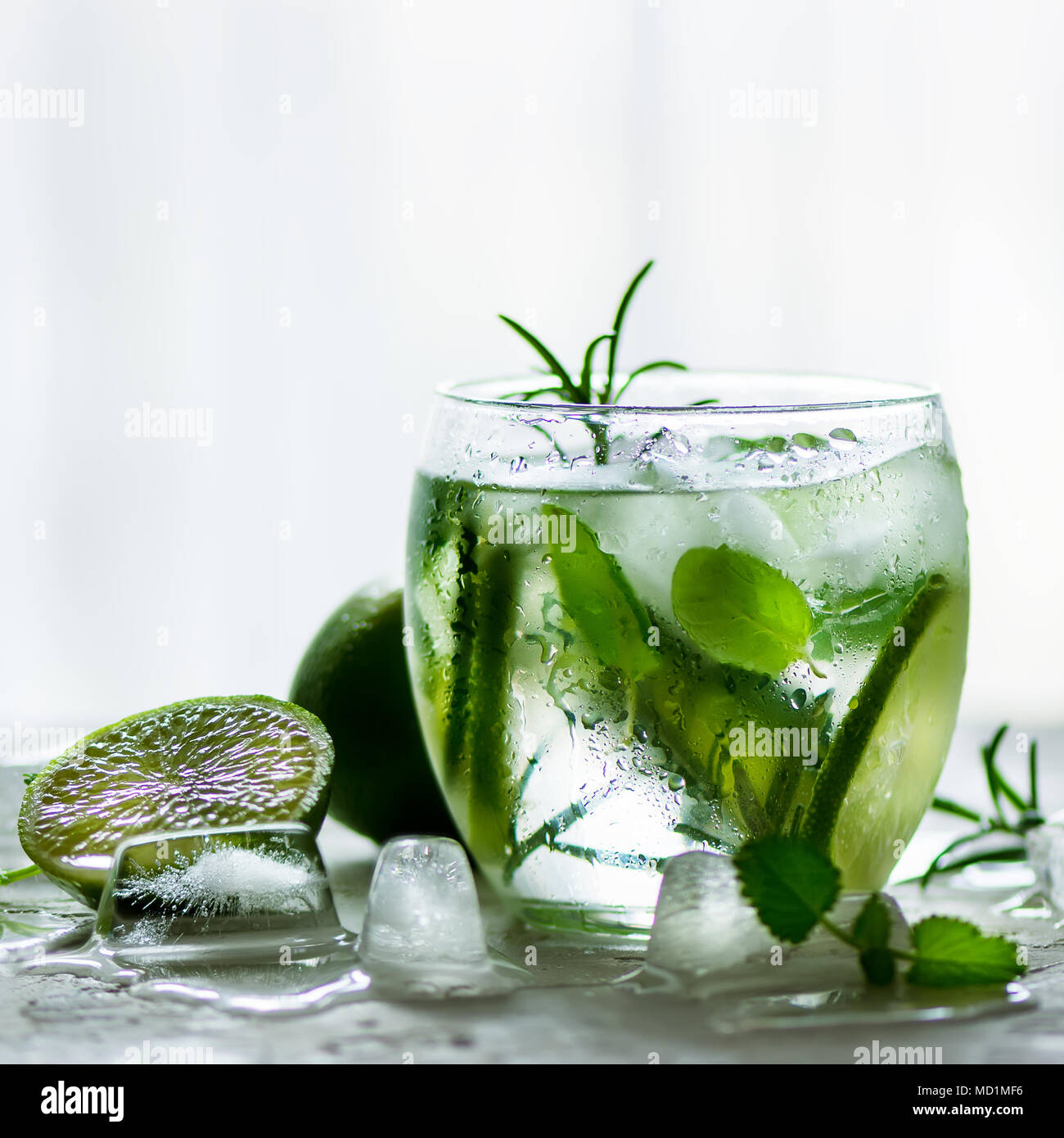 Homemade lime lemonade with cucumber, rosemary and ice, white ...