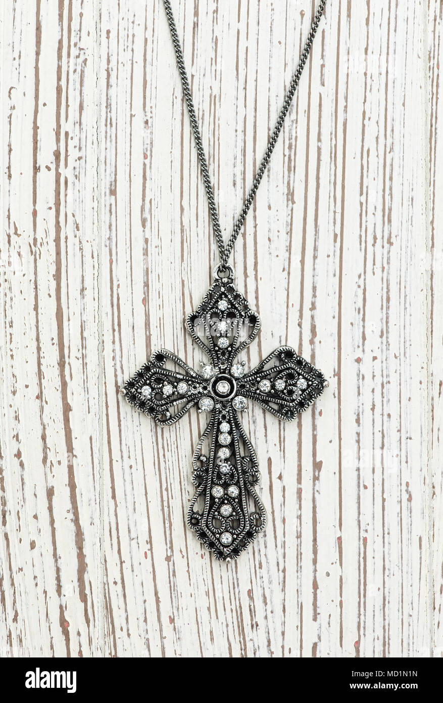 Vintage cross pendant on wood, retro colors background Stock Photo - Alamy