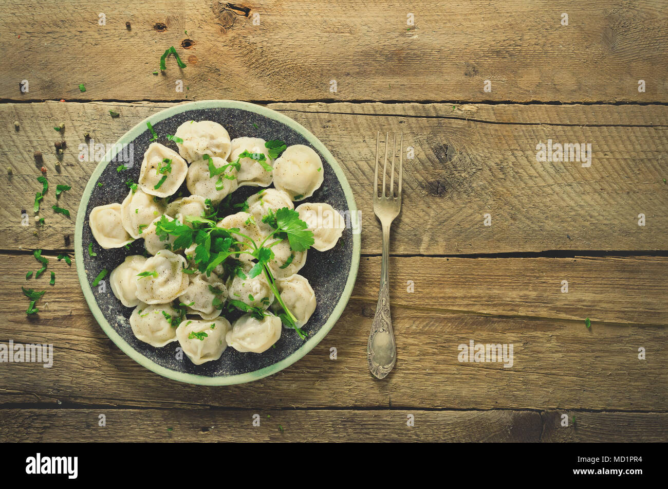 Traditional russian pelmeni, ravioli, dumplings with meat on wooden ...