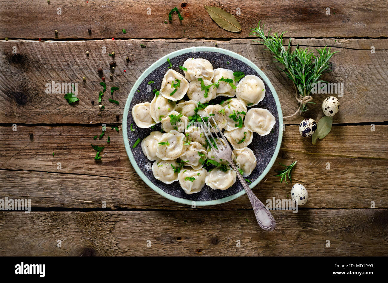 Traditional russian pelmeni, ravioli, dumplings with meat on wooden ...