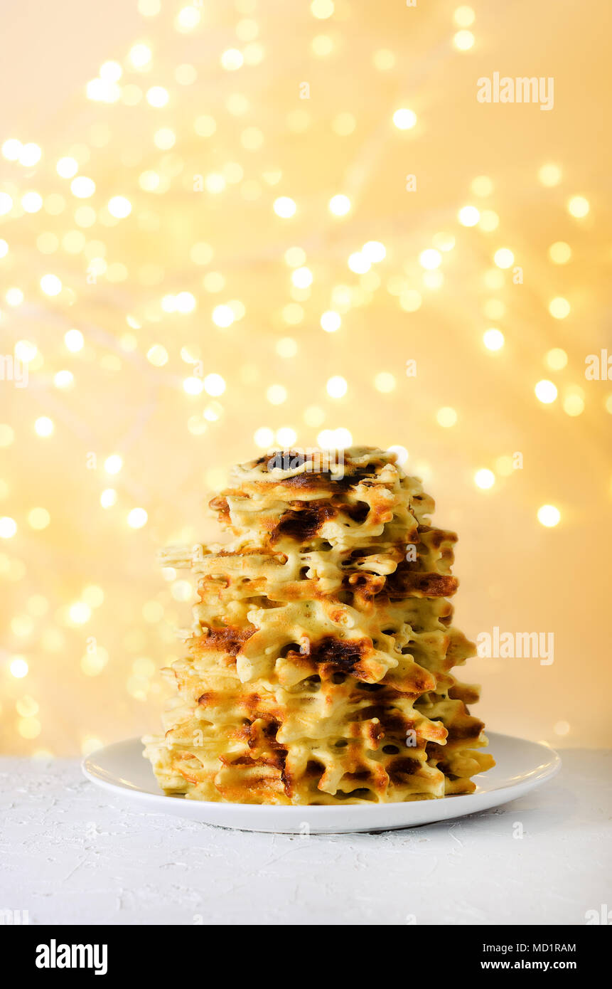 Traditional cake Shakotis, Sakotis on white plate, festive background ...