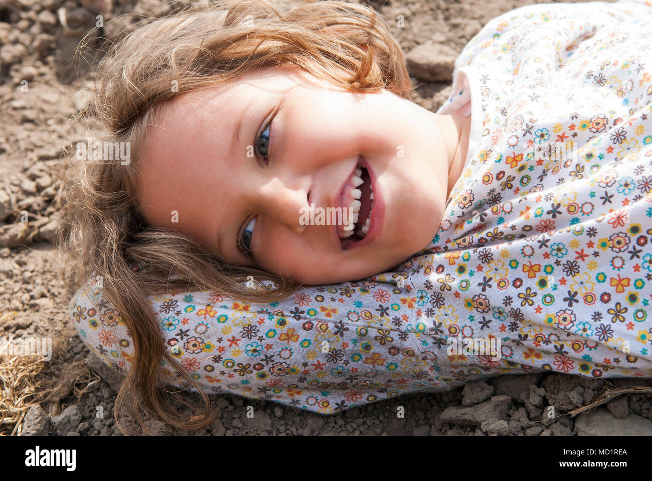 Girl laying on the ground hi-res stock photography and images - Alamy