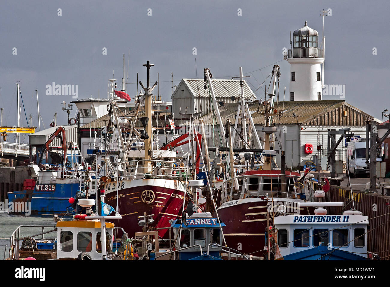 A variety of fishing vessels moored in the harbour near to Scarborough ...