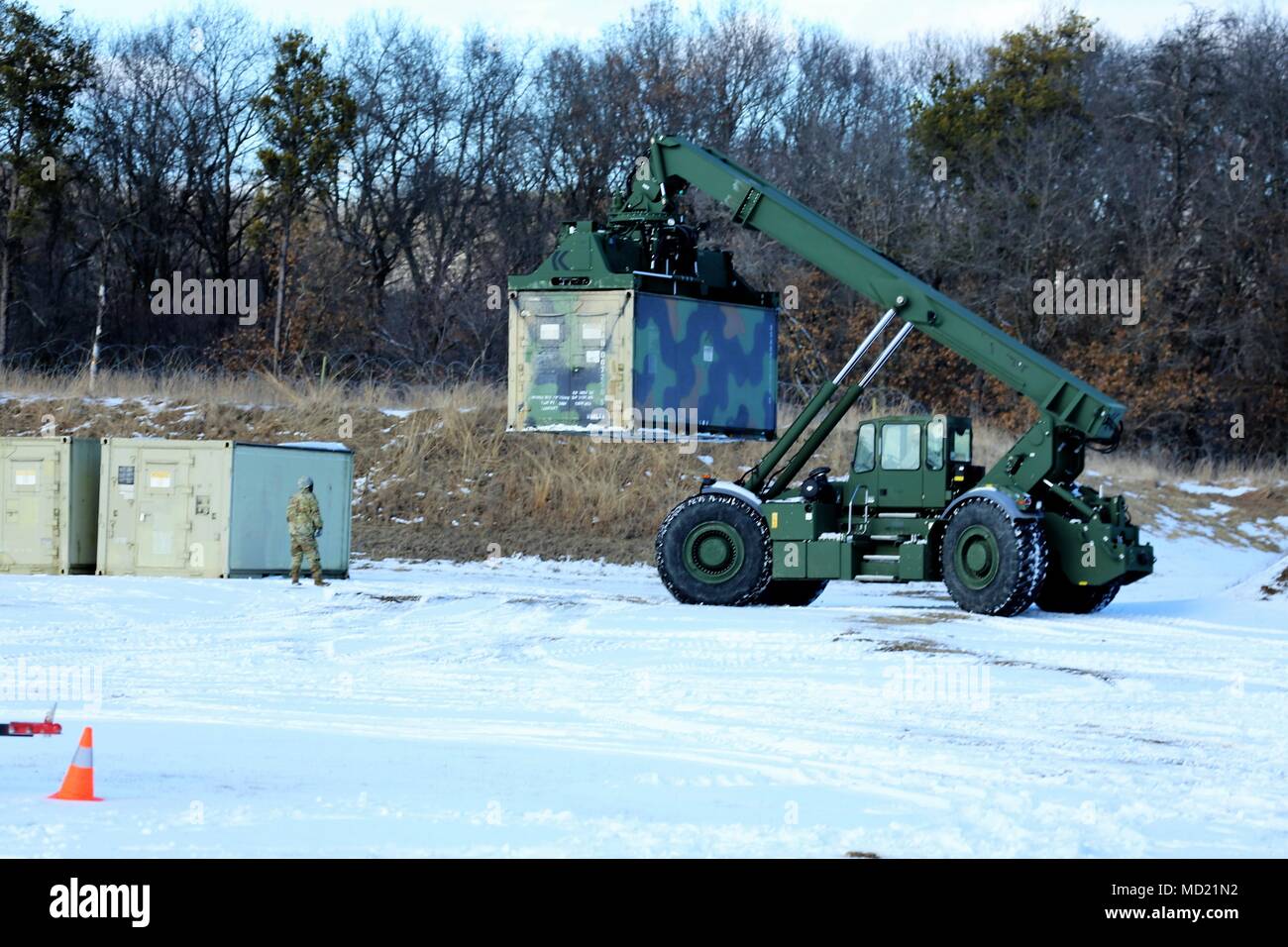 A heavy-equipment operator uses a Rough-Terrain Container Handler ...