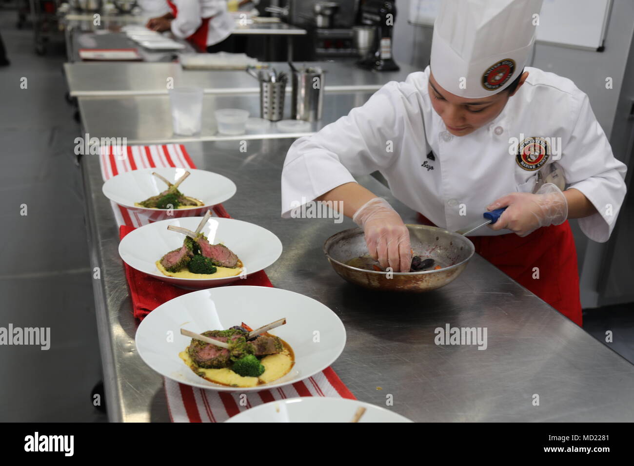 Cpl. Keny Lazo, U.S. Marine Corps food service specialist, puts the ...