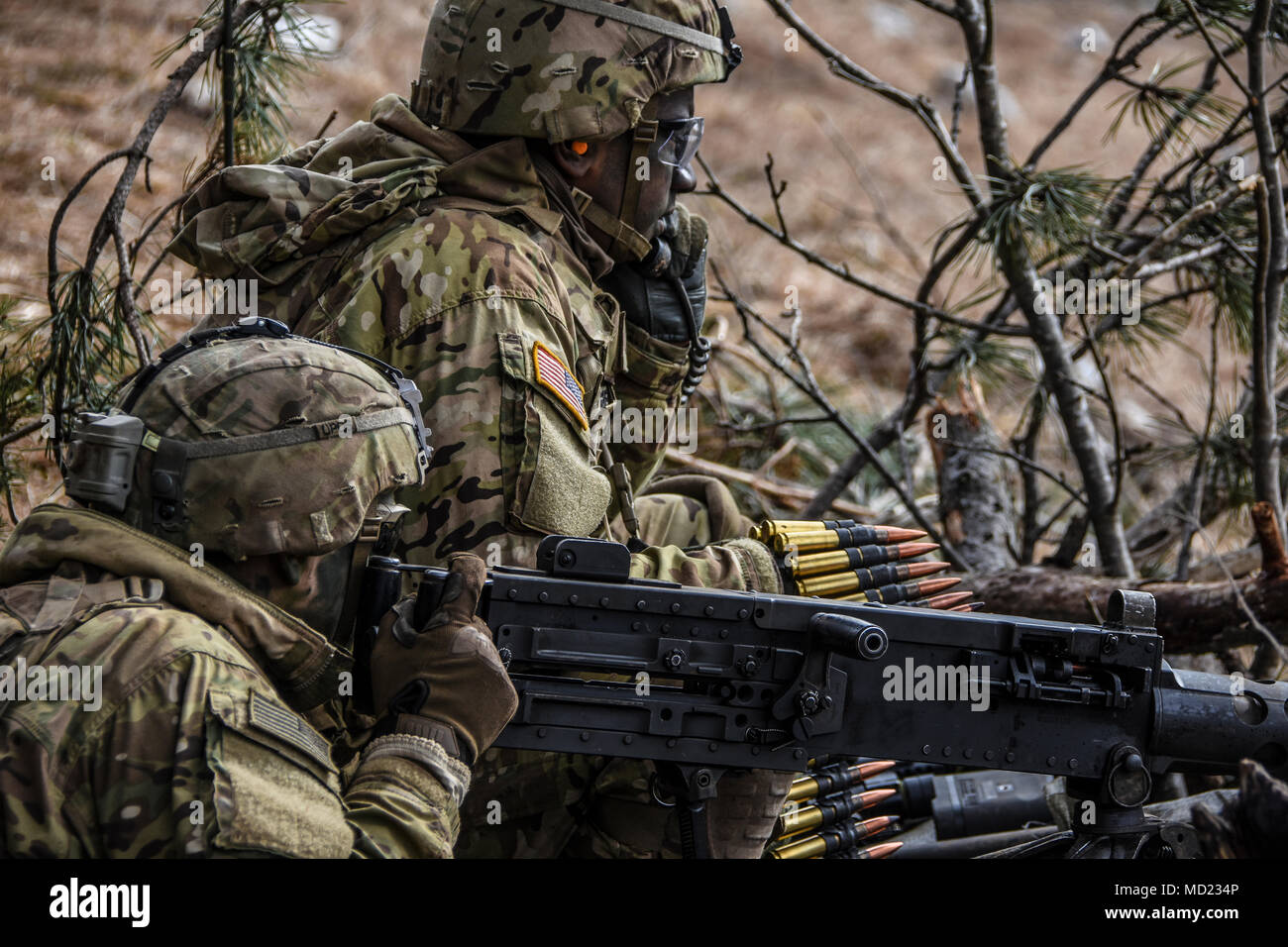An assistant gunner feeds .50 cal. rounds as the gunner engages targets ...