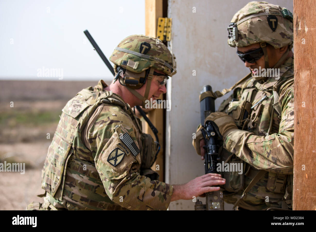 U.S. Army 1st Sgt. Nellessen, with 10th Mountain Division, buddy clears ...