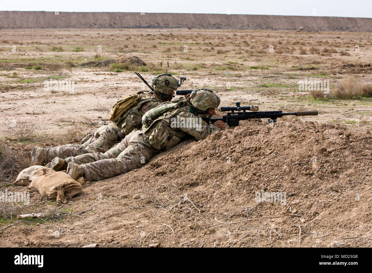 U.S. Army Spc. Lorenzo, with 10th Mountain Division, fires a M40A6 ...