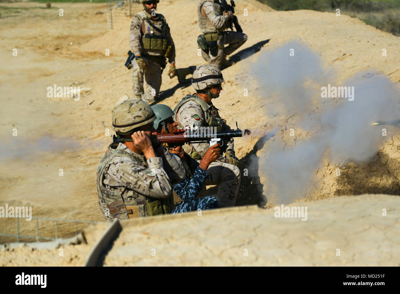 Iraqi Federal Police members fire rocket propelled grenades during a ...