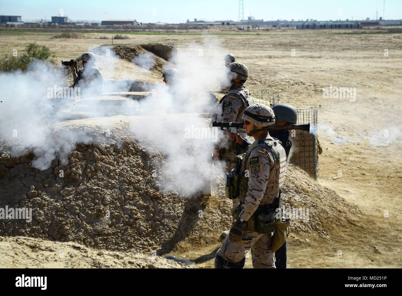 Iraqi federal police members fire rocket propelled grenades during a ...