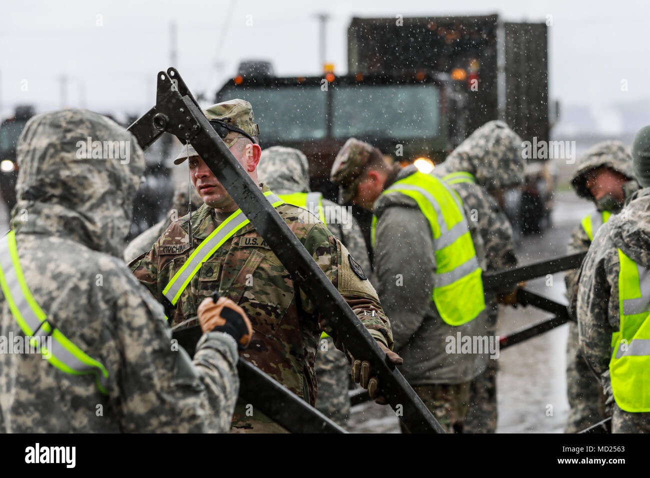 U.S. Army Reserve Soldiers construct a mobile maintenance tent during ...