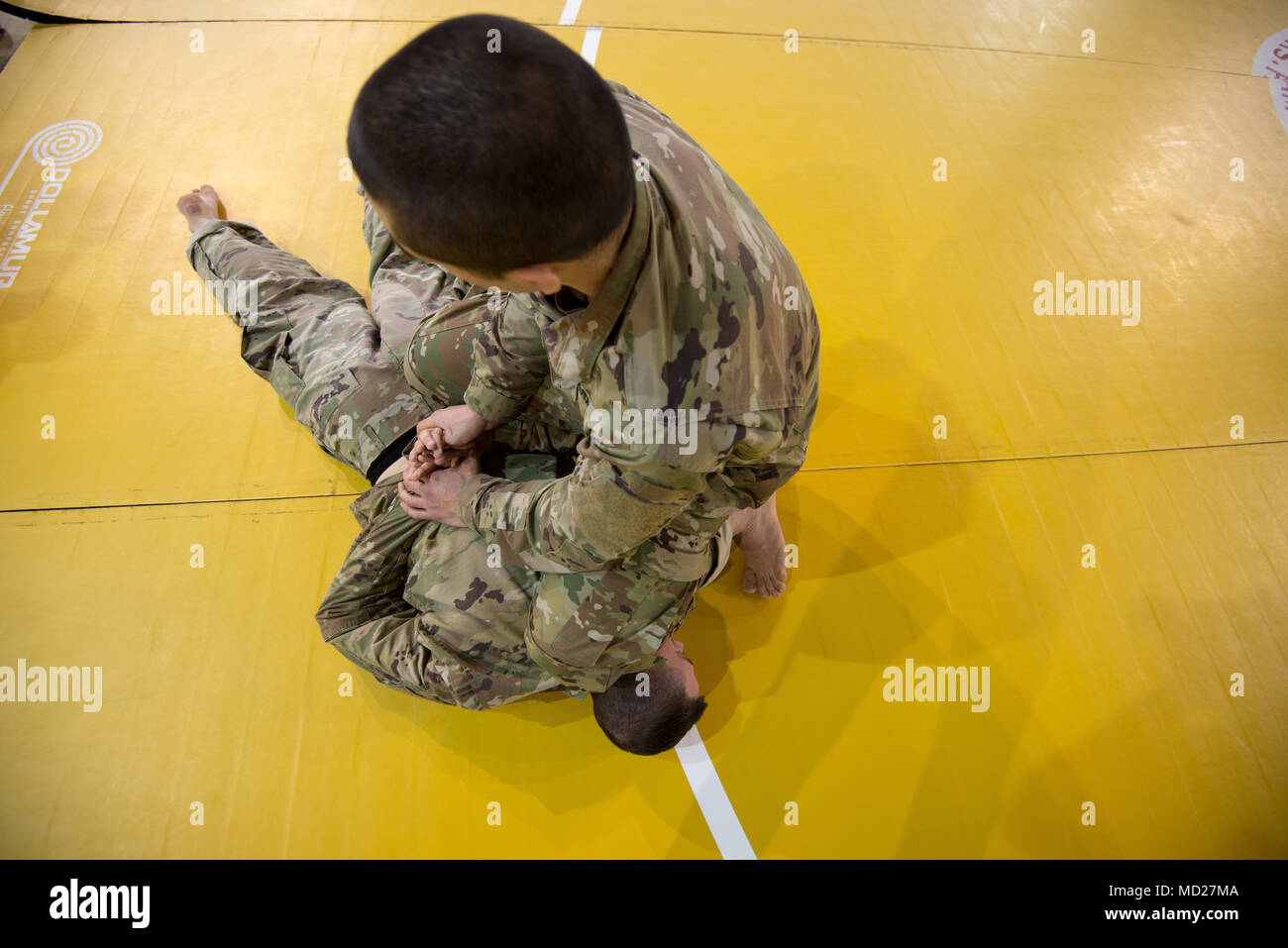 U.S. Army Sgt. Christopher Nathan, simulates cuffing on Spc. Jacob Ruth ...