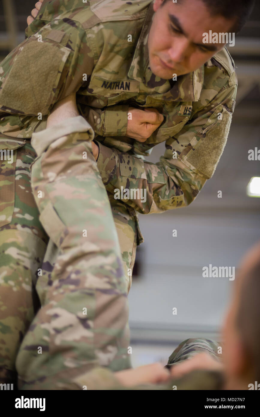 U.S. Army Sgt. Christopher Nathan, executes a leg lock on Spc. Jacob ...