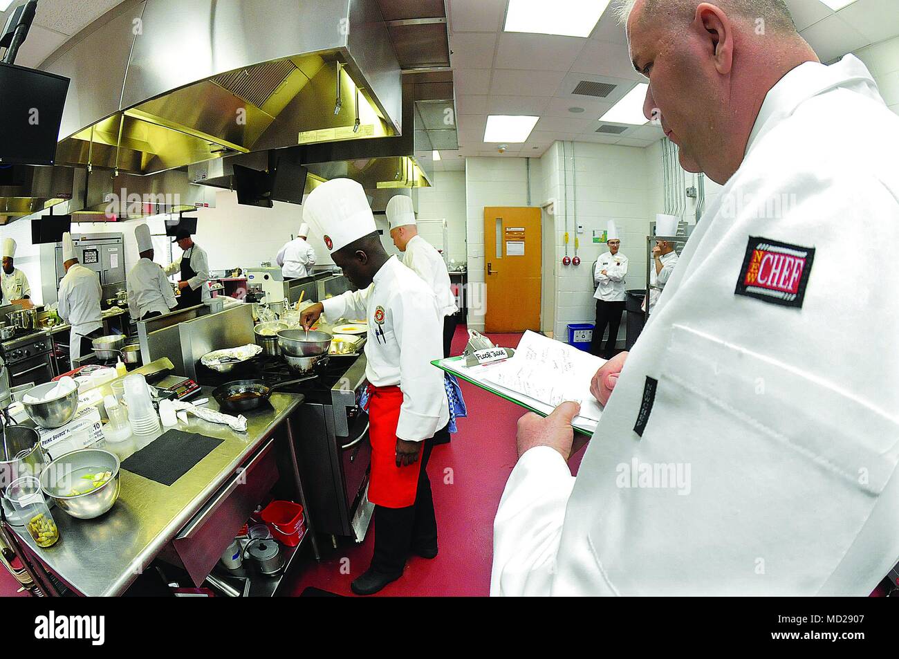American Culinary Federation Judge Brandon Parry looks over contestants ...