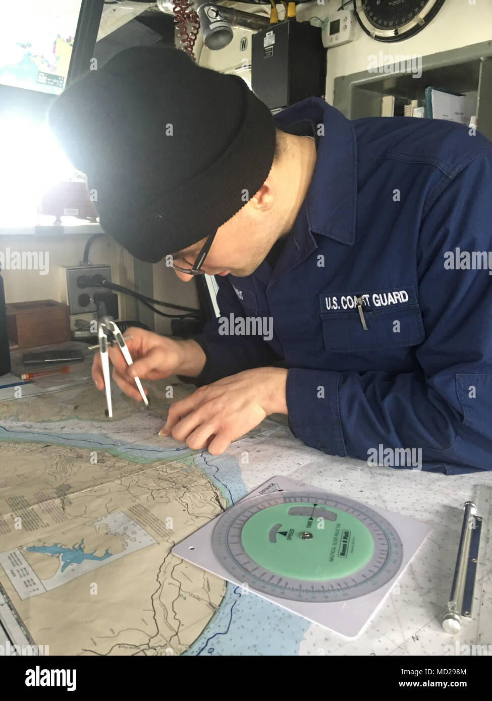 A Coast Guard Cutter Naushon (WPB 1311) crew member practices plotting ...