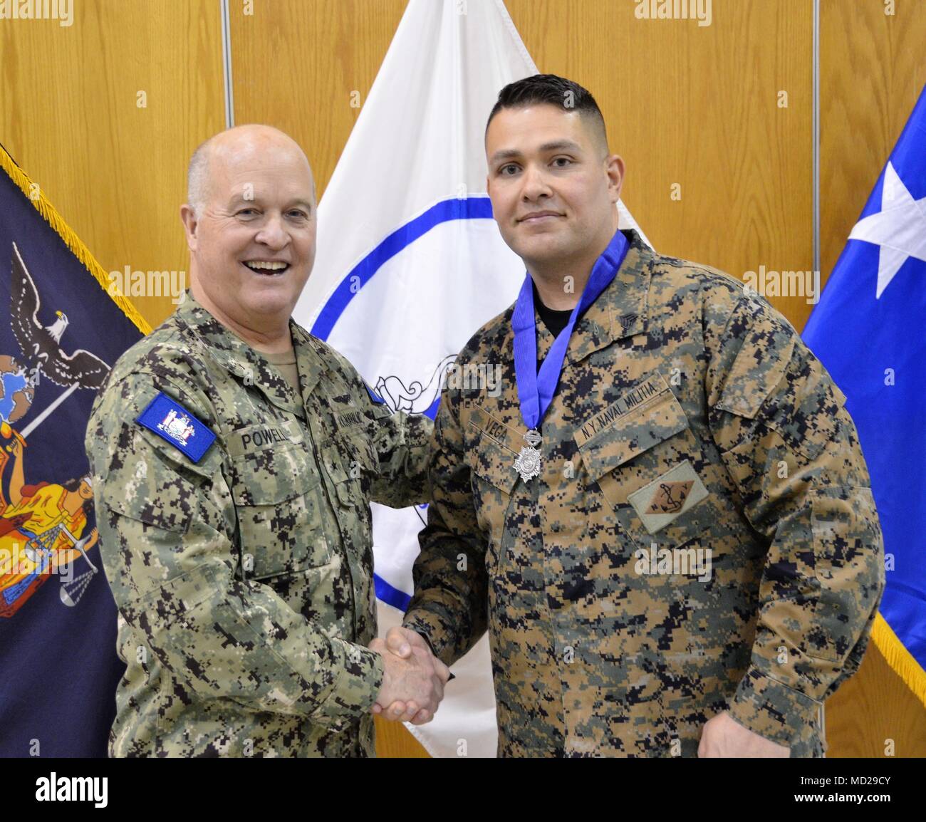 New York Naval Militia Sgt. Christopher Vega, right, is congratulated ...