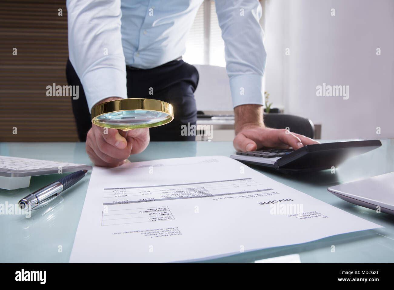 Close-up Of A Businessperson's Hand Holding Magnifying Glass Over ...