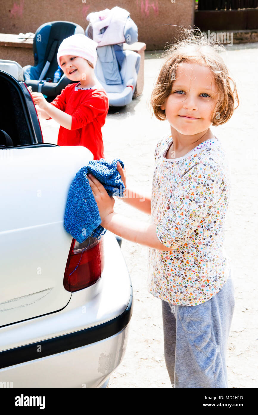 Sisters helping out with washing and cleaning a car Stock Photo - Alamy