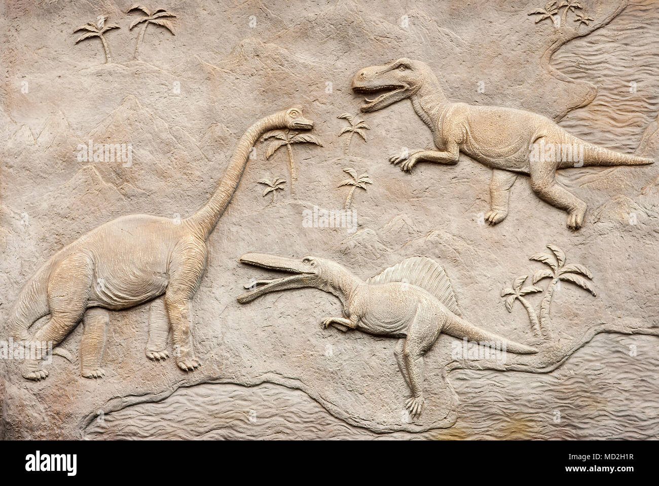 Dinosaurs bas relief on the wall Stock Photo - Alamy