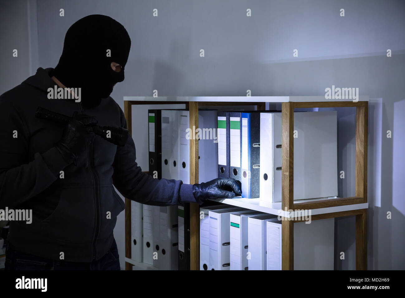Thief Wearing Balaclava Stealing File From Shelf At Workplace Stock ...