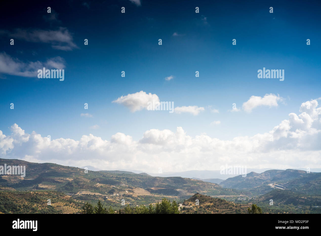 Scenic view of field and mountain against cloudy sky, Crete, Greece ...