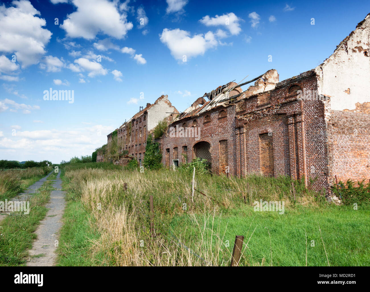 Abandoned ruins of brick structure and grass field Stock Photo - Alamy