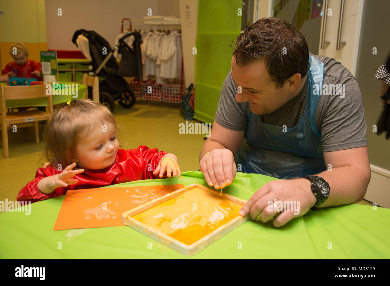 Father and daughter at messy play Stock Photo - Alamy